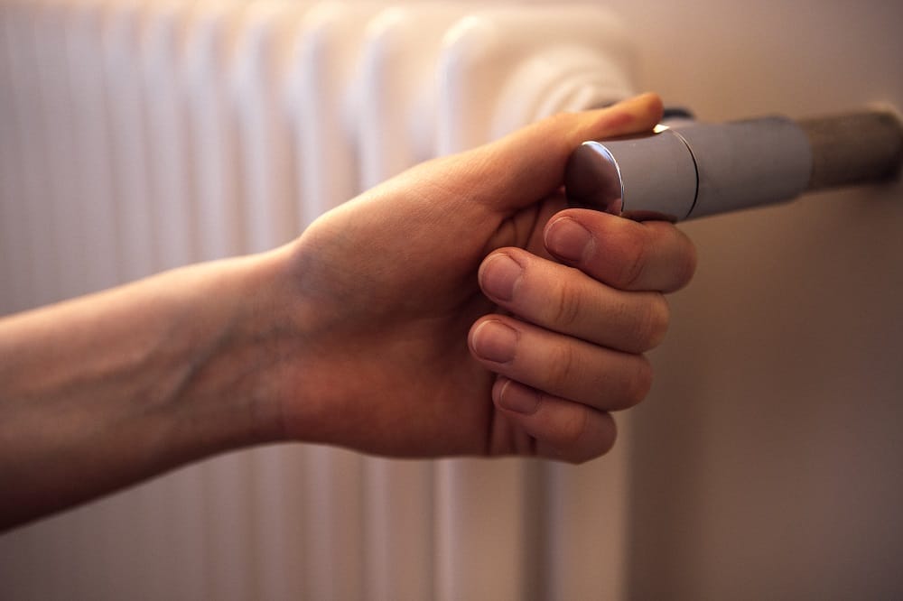 What causes a leaking radiator valve and how do I fix it?