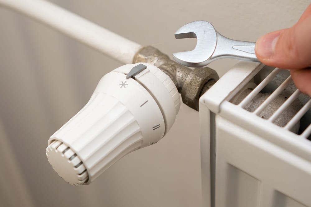 What causes a leaking radiator valve and how do I fix it?